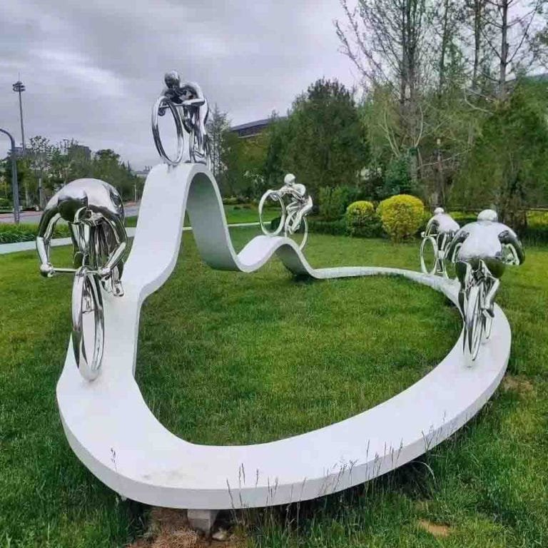 5 Cyclist Sculptures Riding Bicycles On The Track